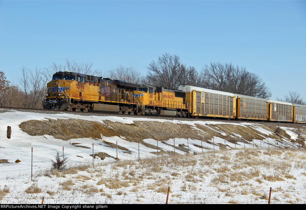 UP 5396 Nasty looking Up unit heads Wb with a auto train.